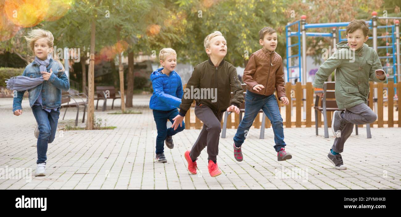 Smiling children playing romp game Touch-last Stock Photo - Alamy