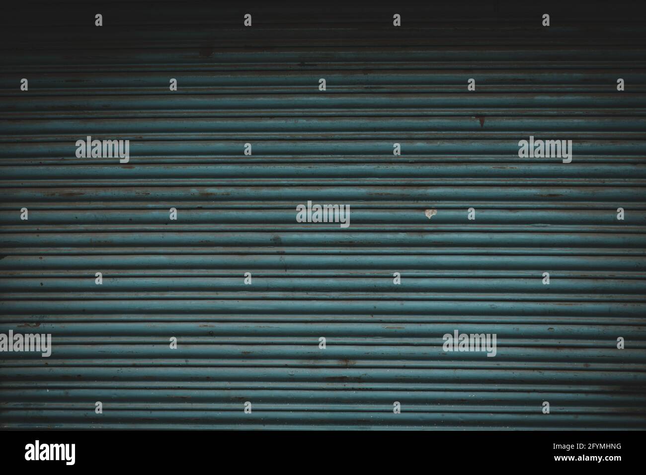Closeup of a rough light blue garage door with a horizontal grid ...