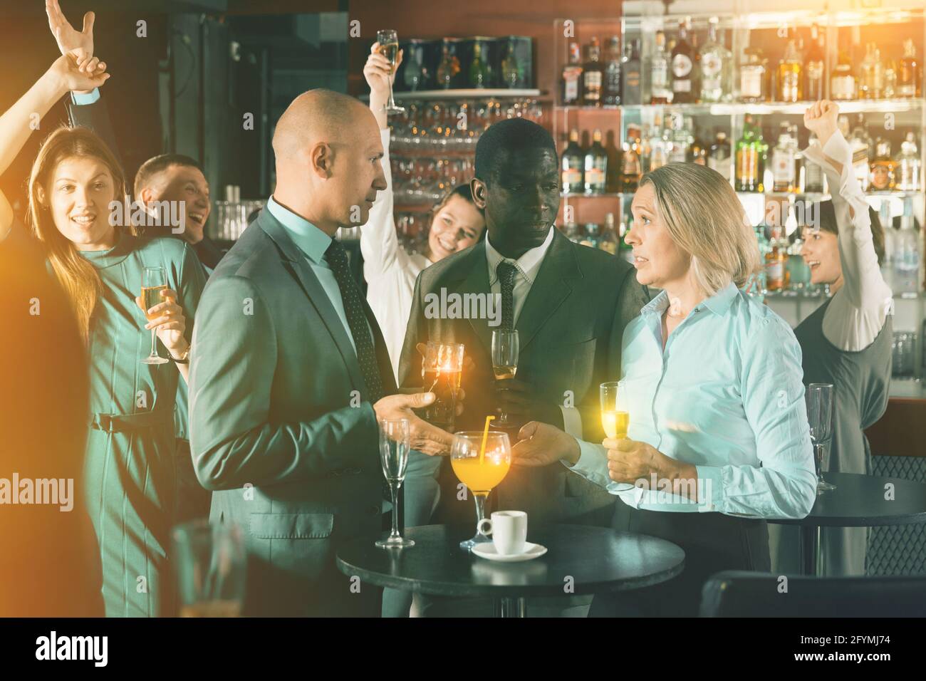 Business colleagues discussing project in informal setting at corporate ...