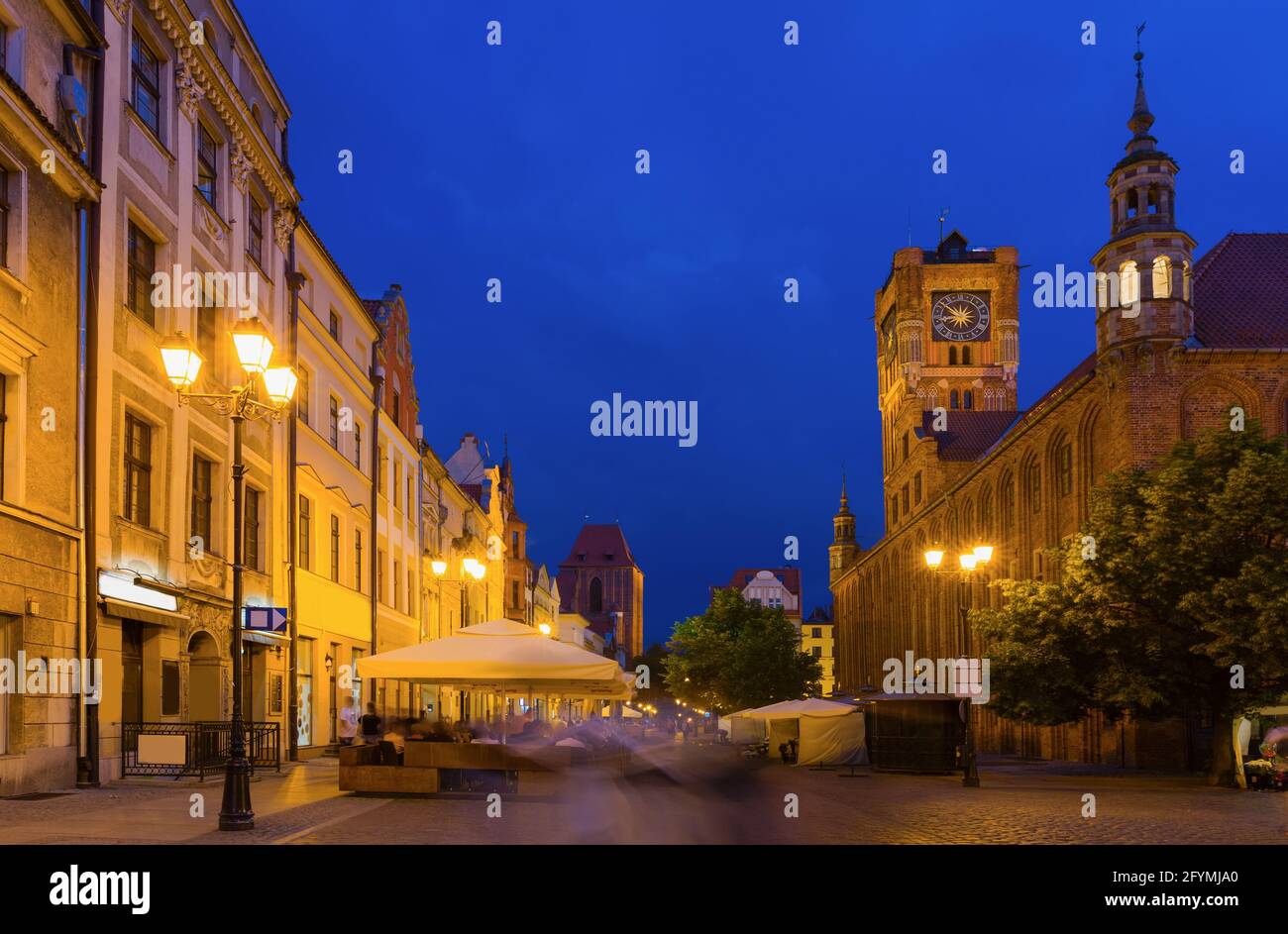 Night view of lighted central Torun square with Old Town Hall and ...