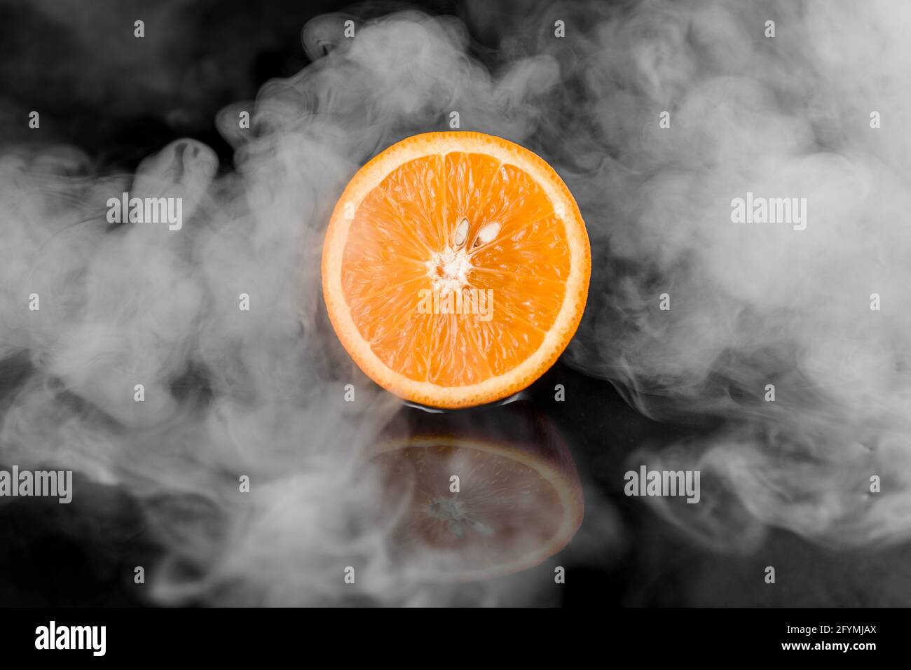 Orange with smoke on black background. Citrus fruit with white smoke of ...