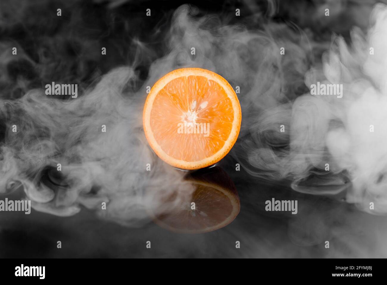 Orange with smoke on black background. Citrus fruit with white smoke of ...