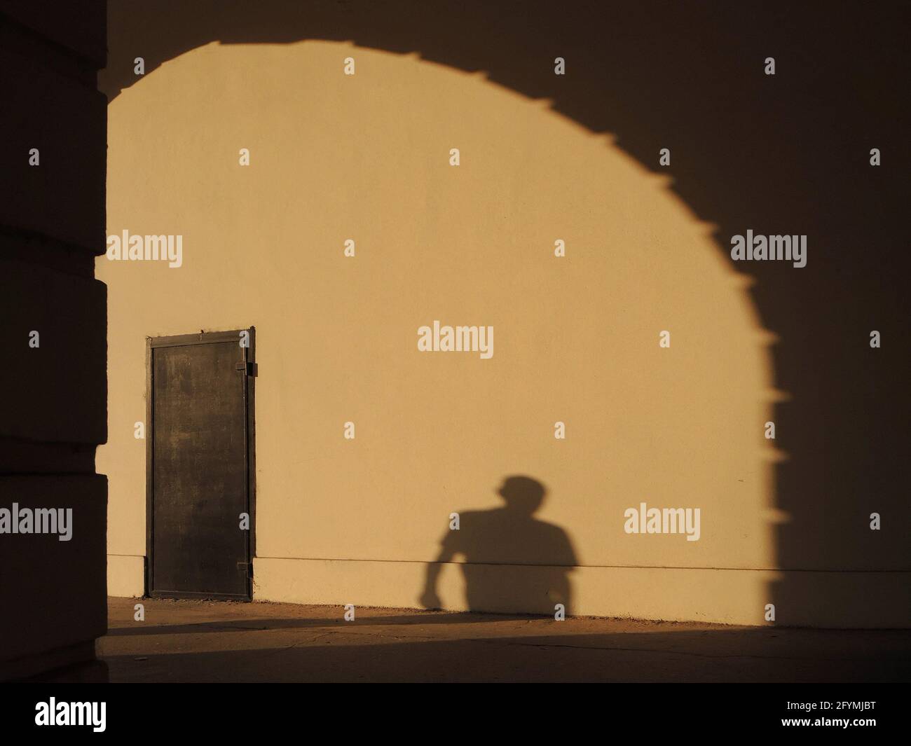 Shadow of a man passing through the hallway next to a door Stock Photo ...
