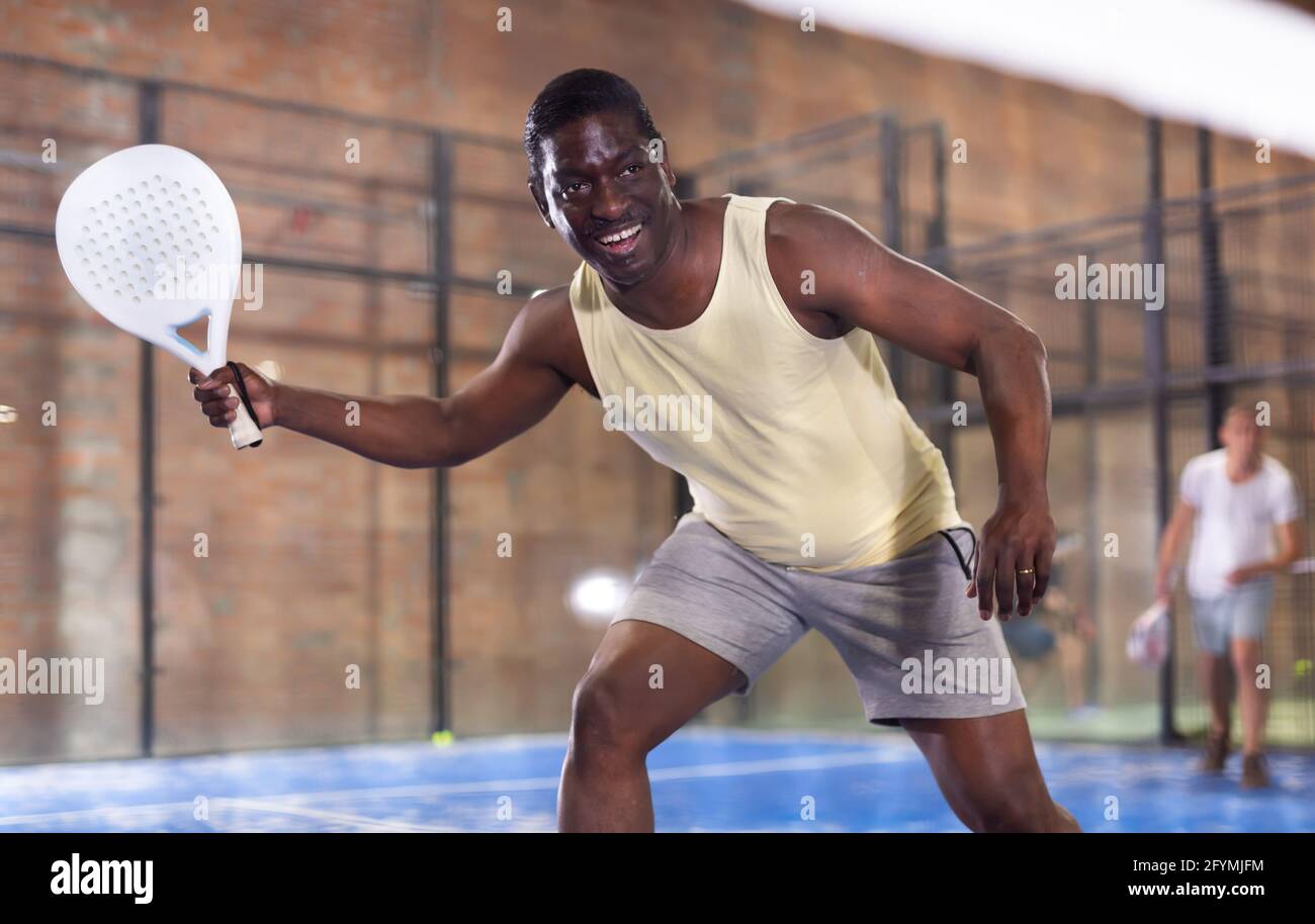 Padel tennis player posing in court Stock Photo - Alamy