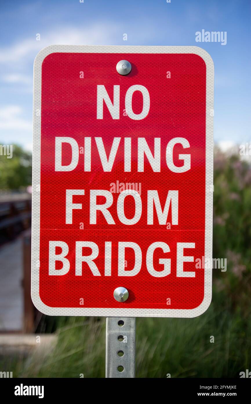 Red sign next to a bridge saying 'no diving from bridge' Stock Photo ...