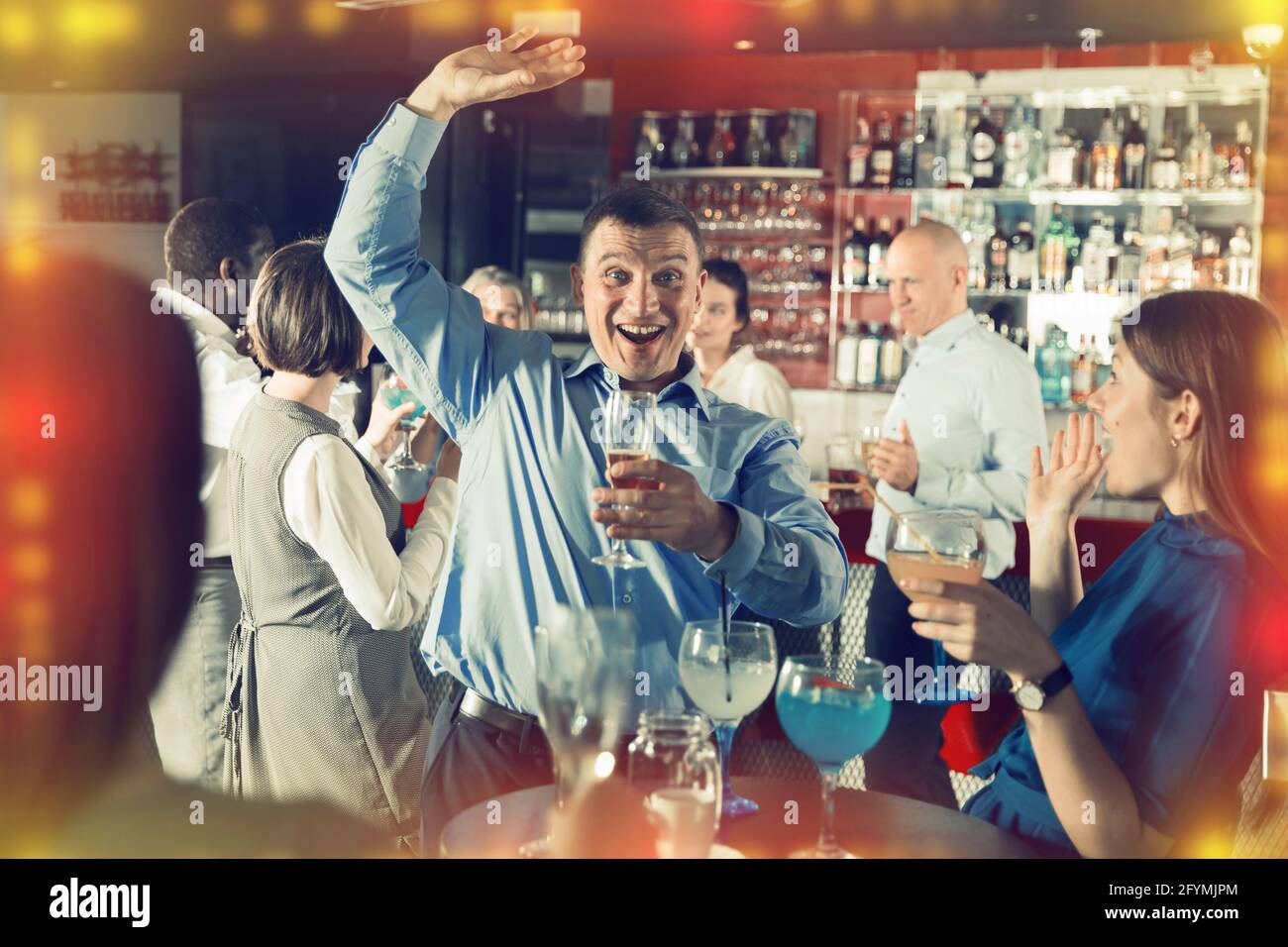 Portrait of cheerful tipsy businessman drinking alcohol and having fun ...
