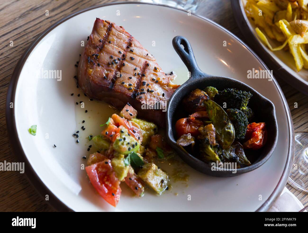 Braised tuna fillet with salad of avocado with tomatoes and baked ...