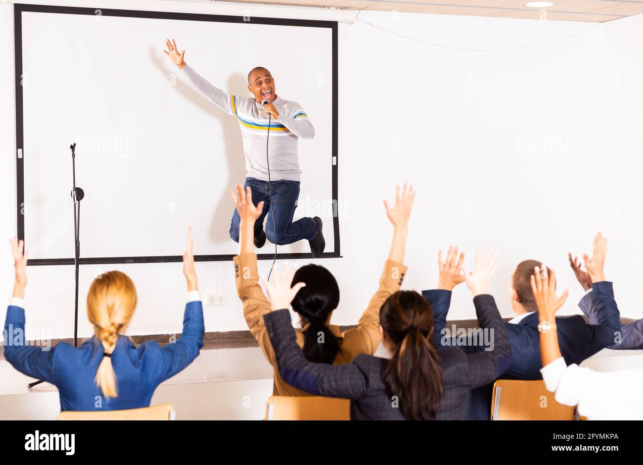 Expressive emotional hispanic business coach speaking to audience and ...