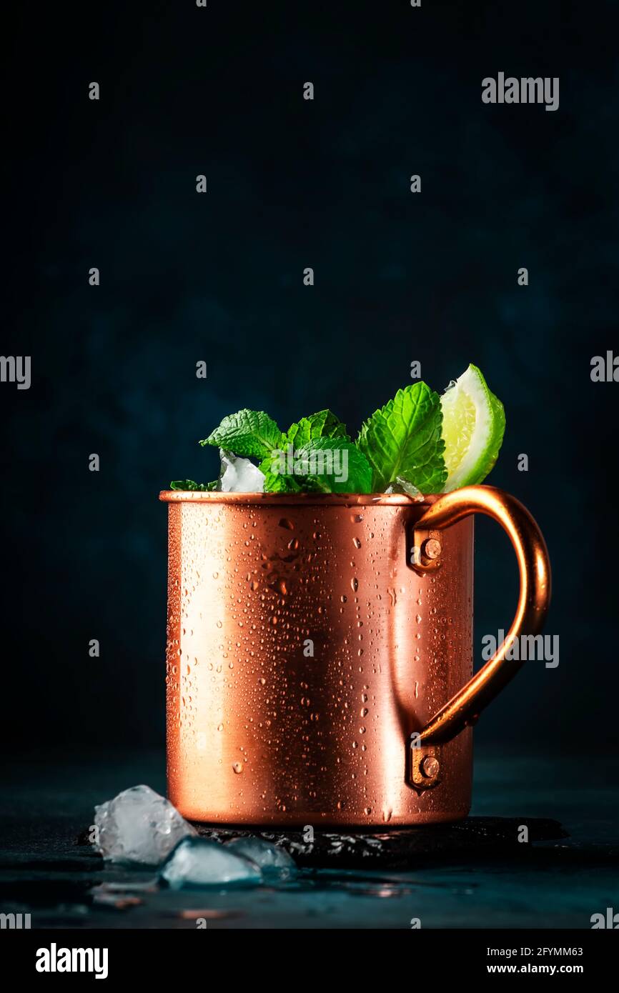 Moscow mule alcoholic cocktail in copper mug with lime, ginger beer ...