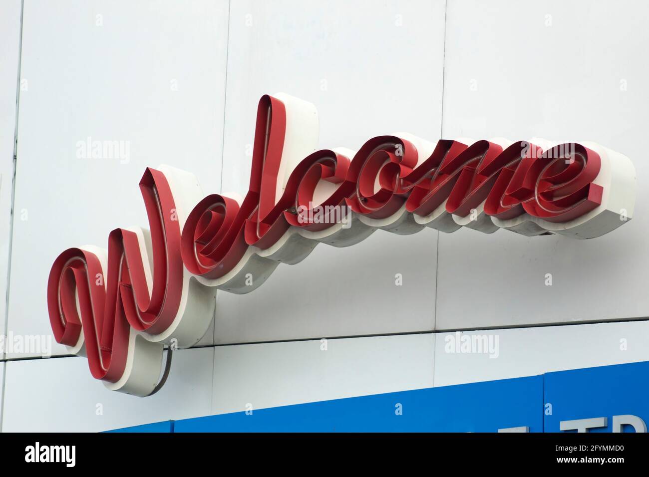 Red sign saying welcome on a white exterior wall Stock Photo - Alamy
