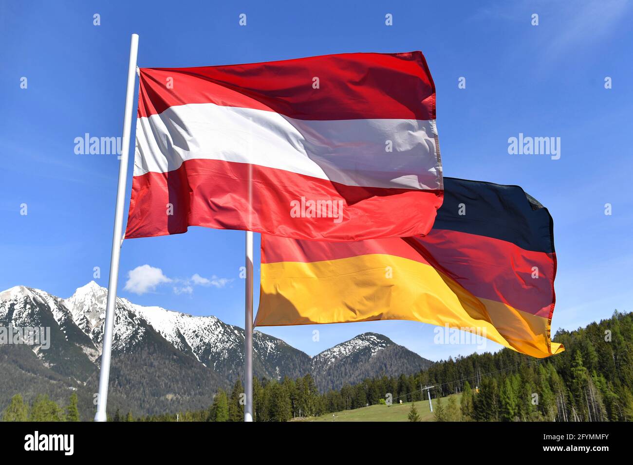 Austrian flag and German flag black red gold flutter in the wind one ...