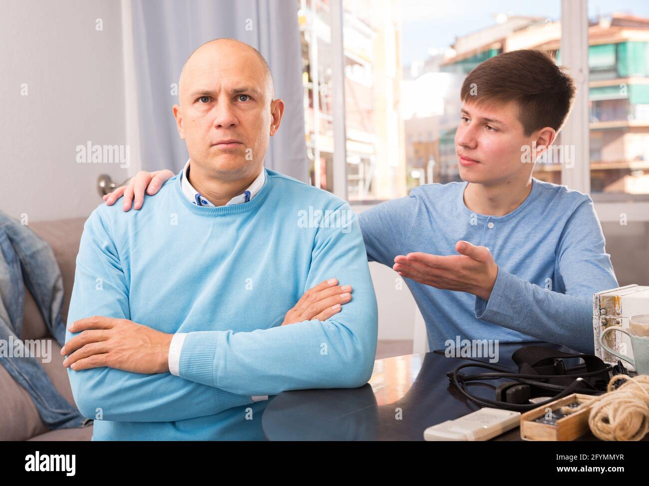 Teenage son asking for forgiveness from his offended father Stock Photo ...