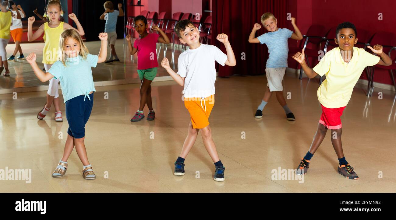 Happy kids trying balance movements of ballet in classroom Stock Photo ...