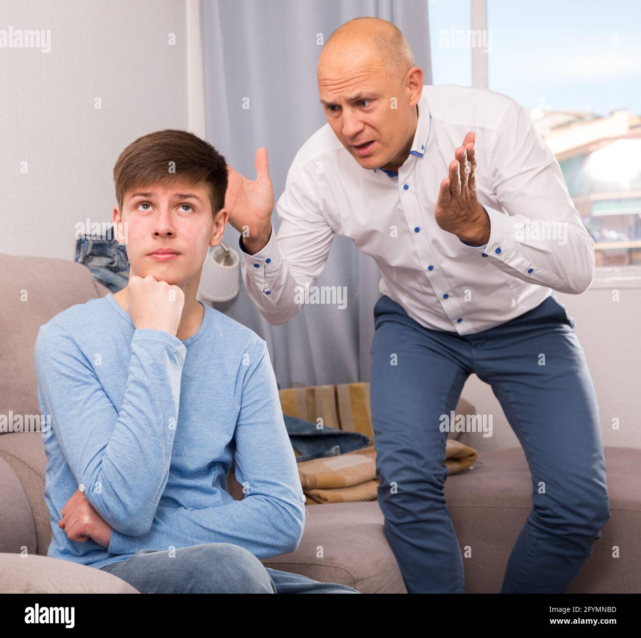 Portrait of angry father quarreling with his teenage son Stock Photo ...