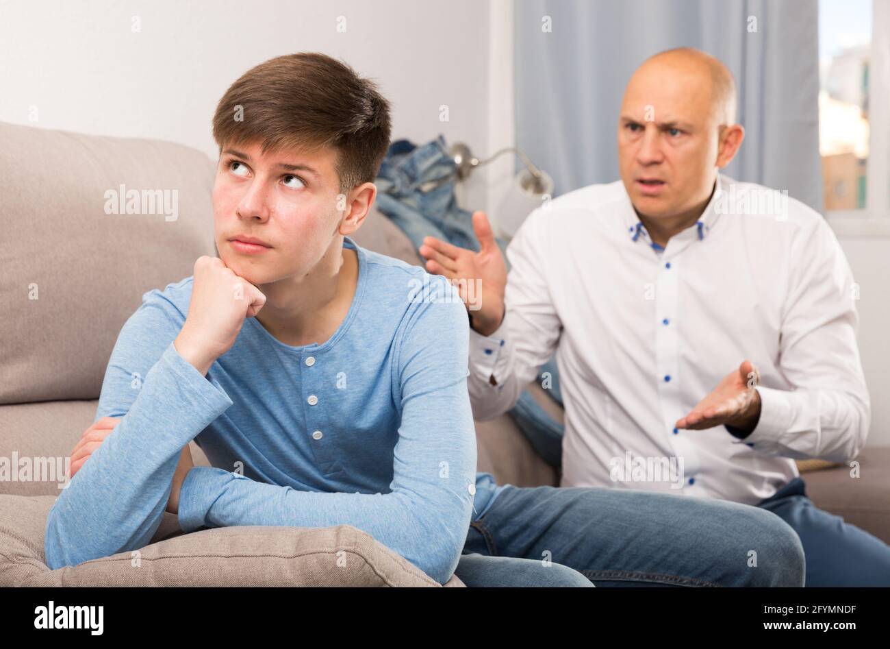 Portrait of angry father quarreling with his teenage son Stock Photo ...