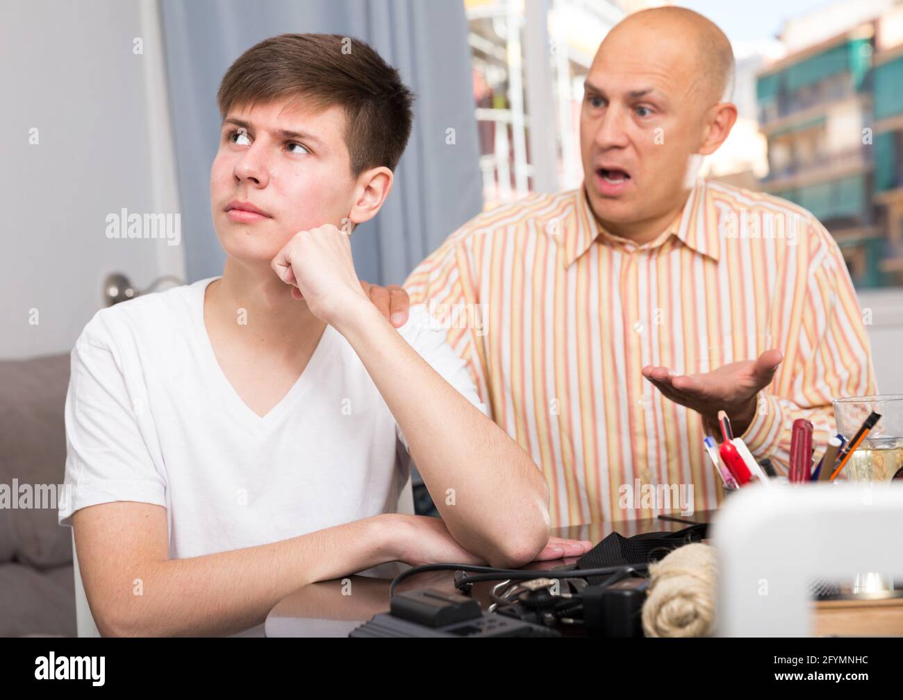 Portrait of angry father quarreling with his teenage son Stock Photo ...
