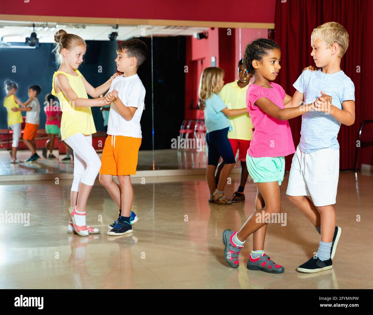 Group of happy cheerful smiling childrens trying dancing with partner ...