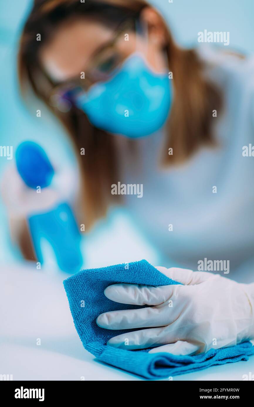Woman disinfecting surface Stock Photo - Alamy