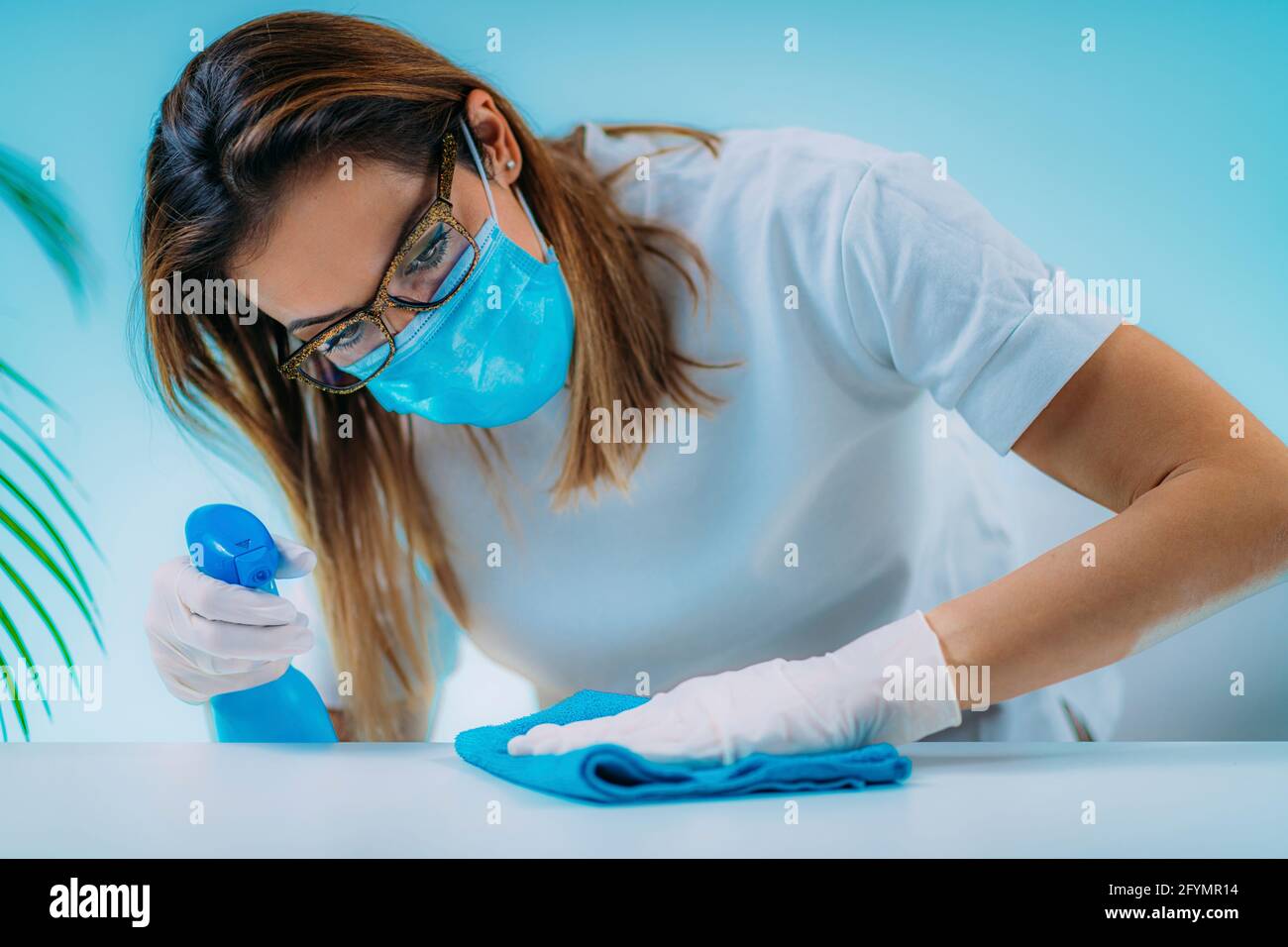 Woman disinfecting surface Stock Photo - Alamy