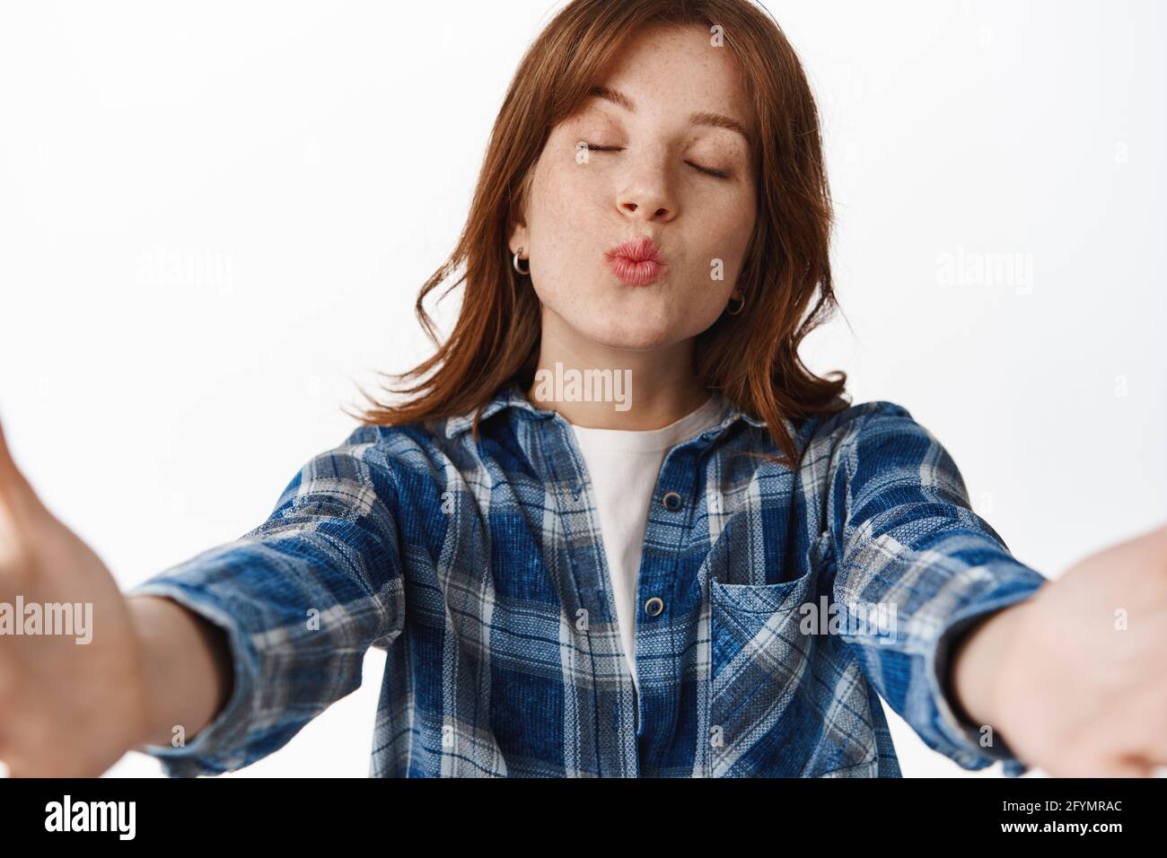 Close up portrait of lovely redhead girl with freckles, close eyes and ...