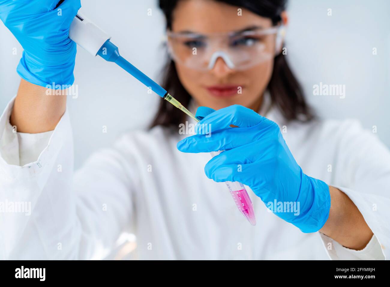 Researcher pipetting sample Stock Photo - Alamy