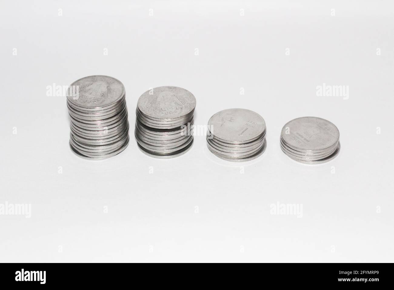 Closeup shot of stacked coins isolated on a white background Stock ...