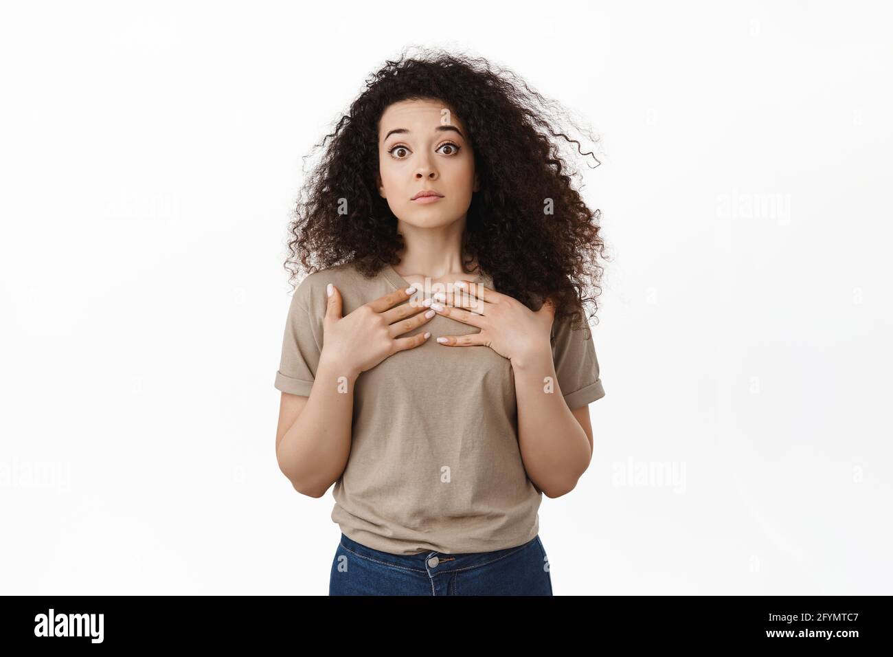 Surprised young woman looking startled, raising eyebrows in disbelief ...
