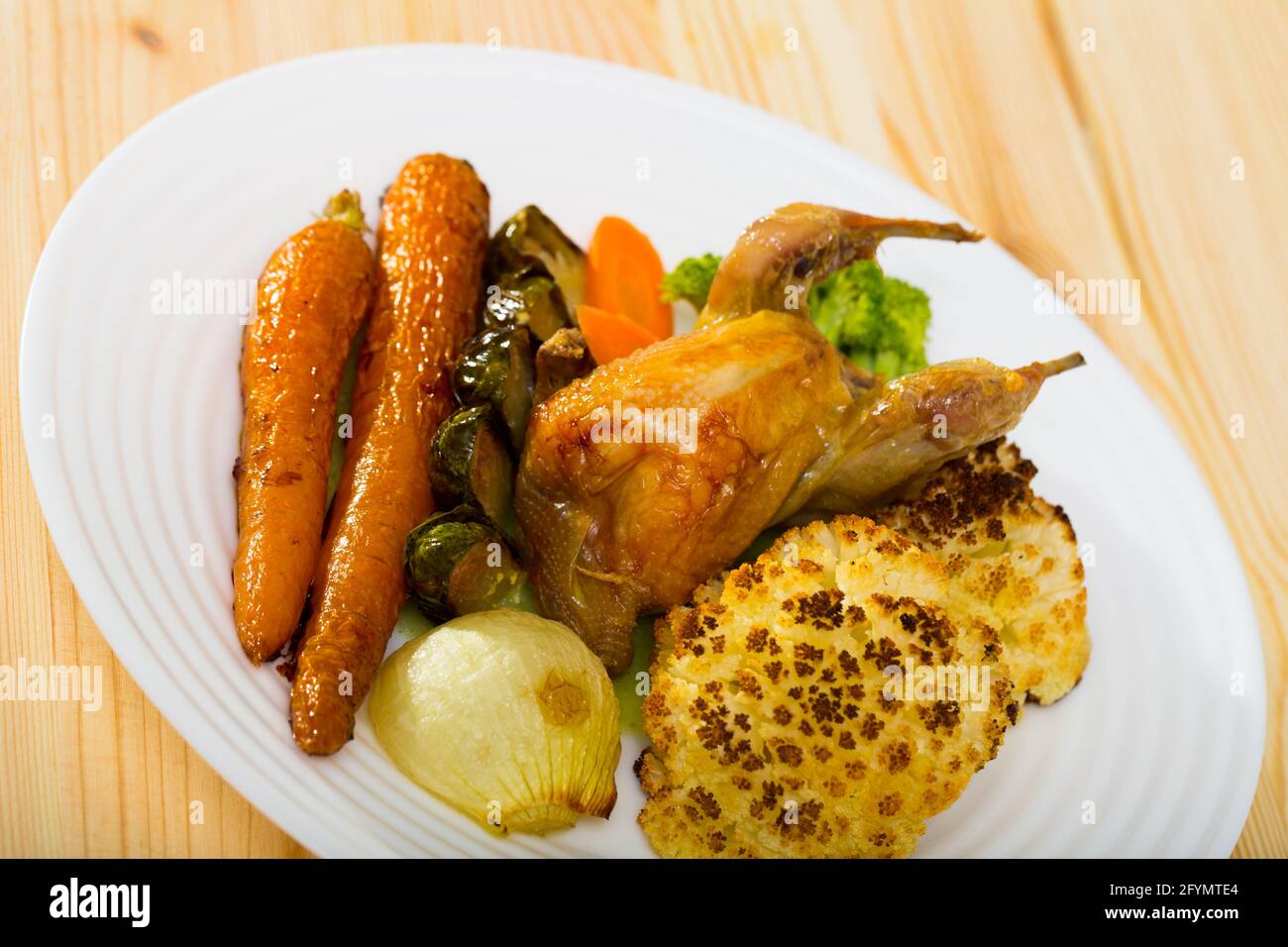 Partridge baked with vegetables in honey-mustard sauce exquisitely ...