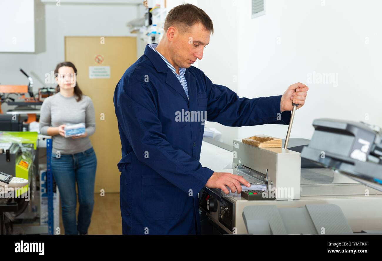 Printing house employee is working on printing at the machine Stock ...