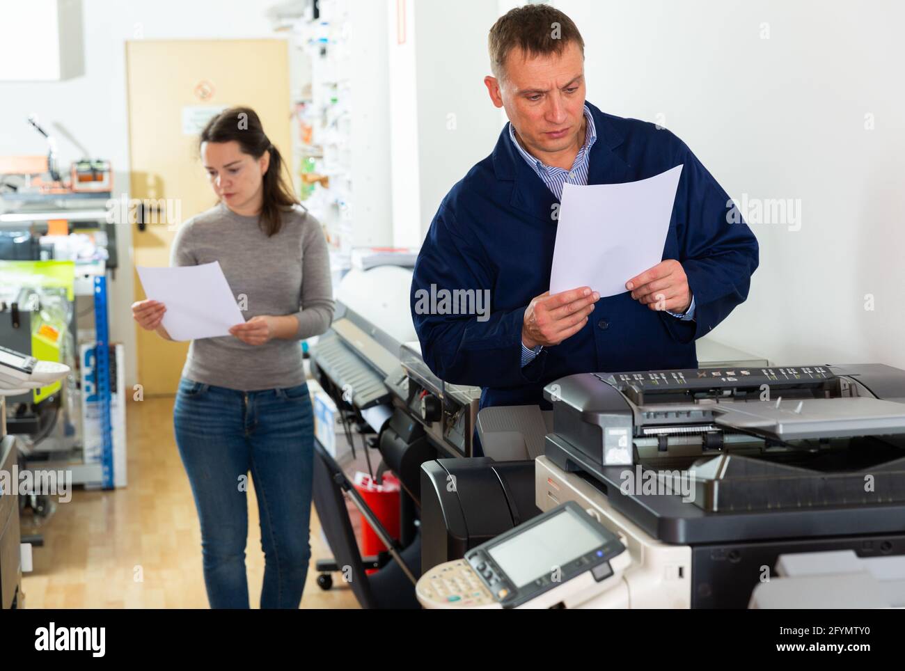 Printing company employees work on various printing machines Stock ...