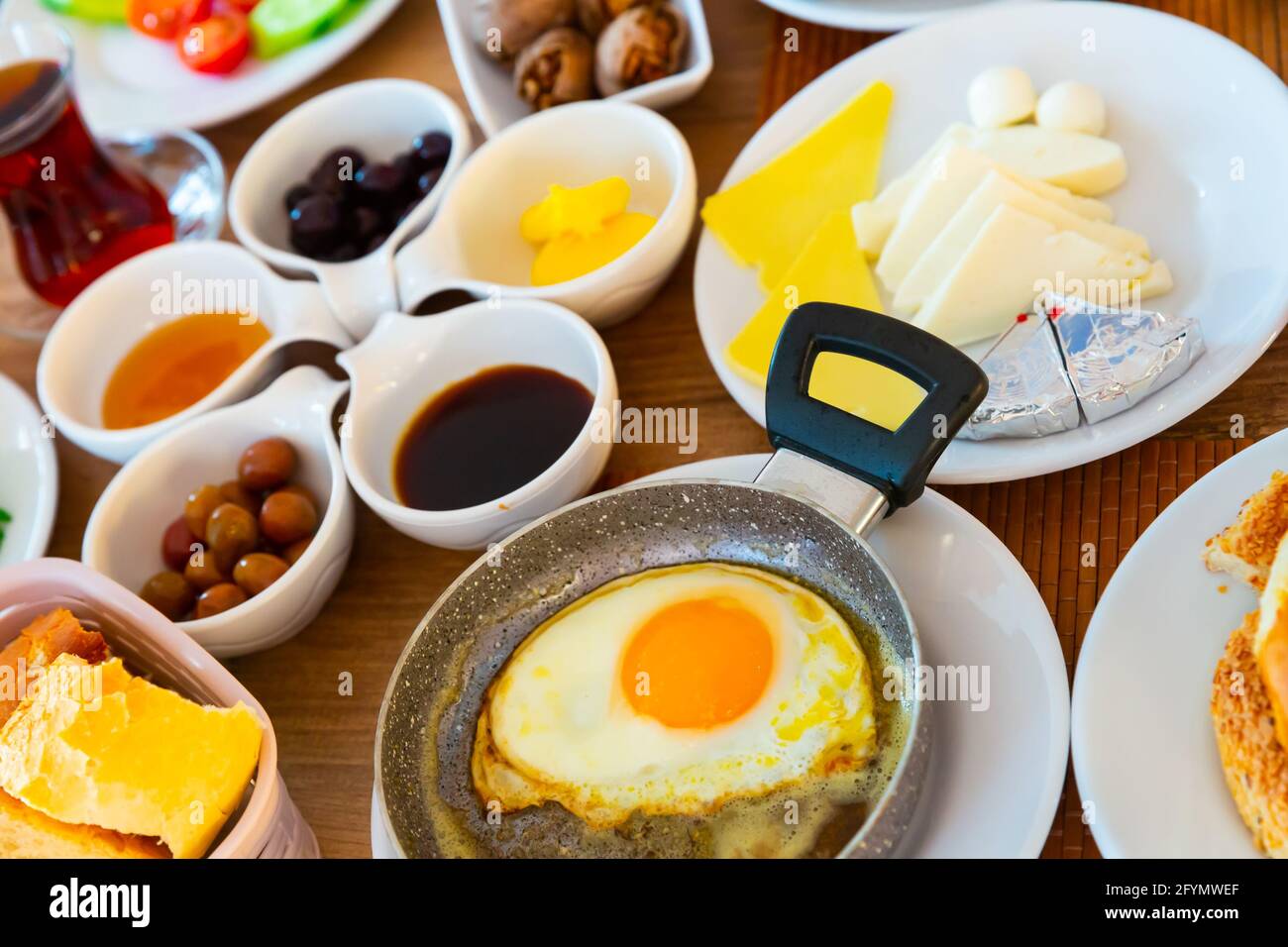 Traditional Turkish breakfast: egg, vegetables, cheeses, olives and ham ...
