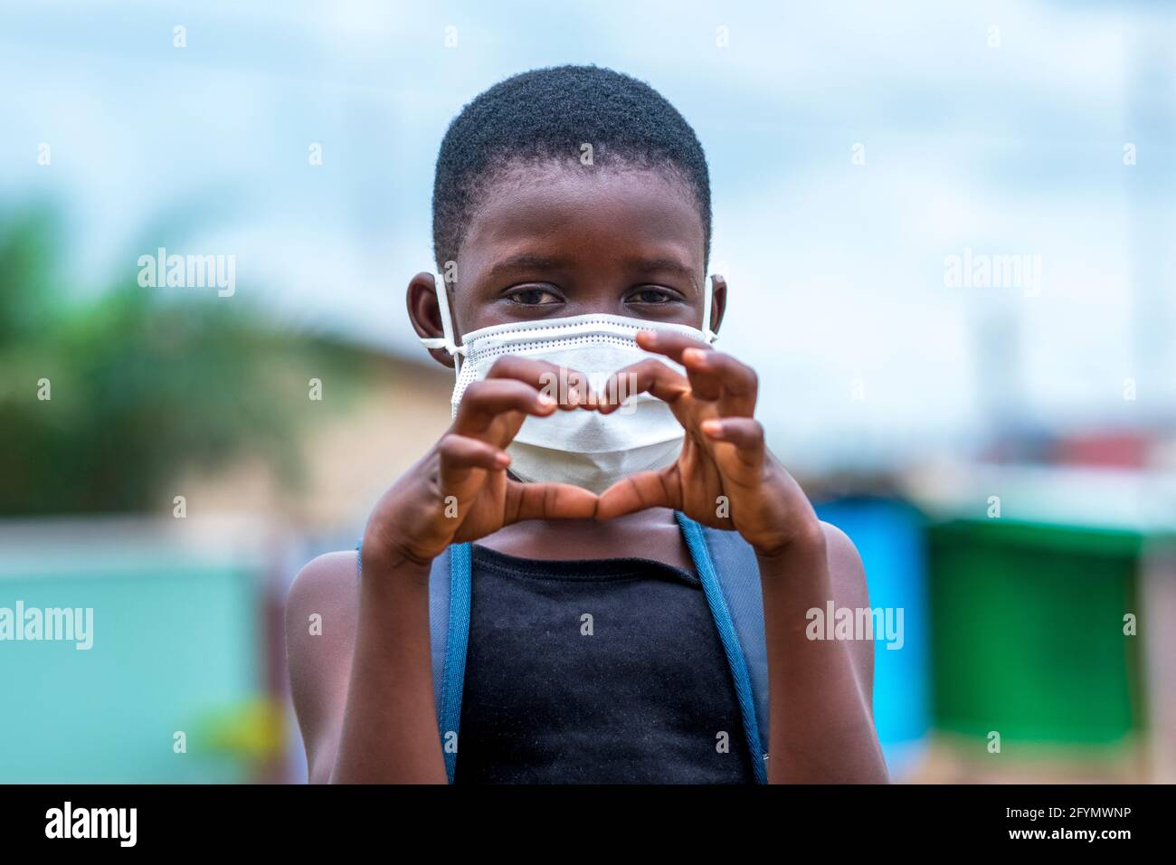 Girl in face mask making heart sign Stock Photo - Alamy