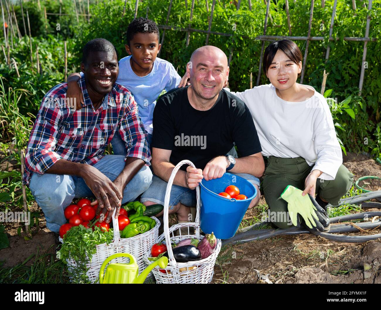 Portrait of friendly international family on farm field Stock Photo - Alamy