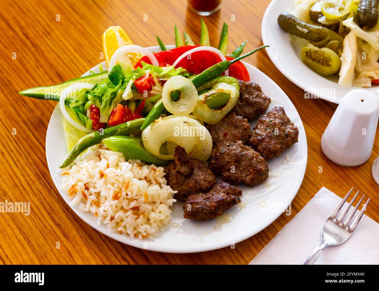 Plate of turkish kofte meatballs with rice and salad Stock Photo - Alamy