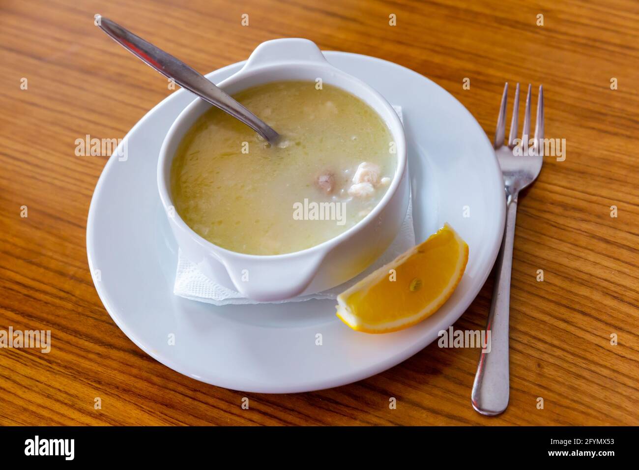 Turkey's famous dish tavuk suyu corba soup served in bowl with lemon ...