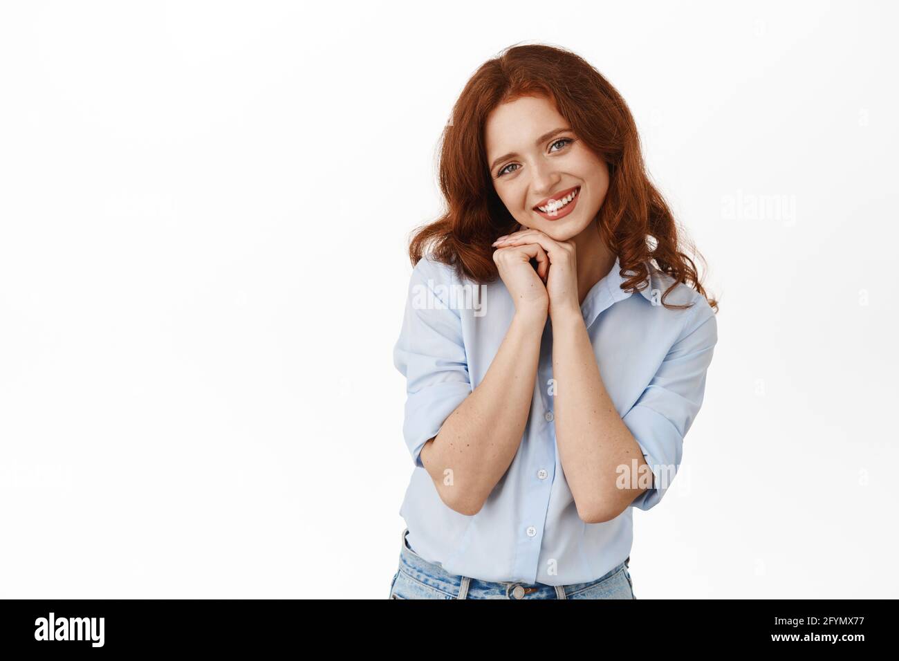 Adorable redhead woman flirting, looking cute and silly, smiling at ...