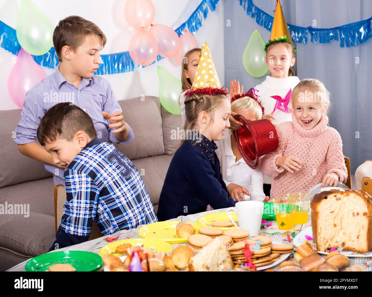Happy children having fun during friend’s birthday party at his home ...