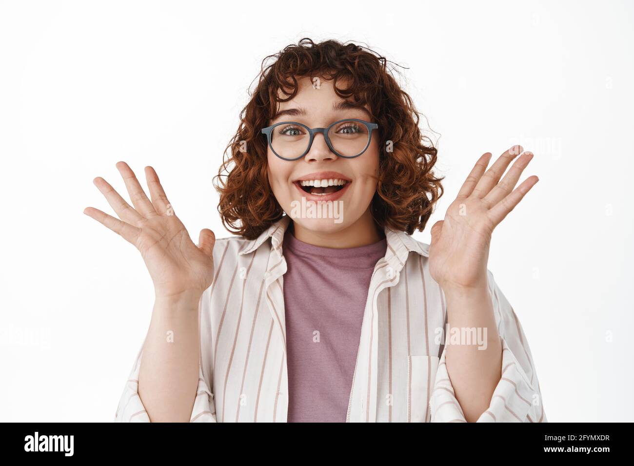 Close up portrait of looks surprised and relieved, clap hands and gasp ...