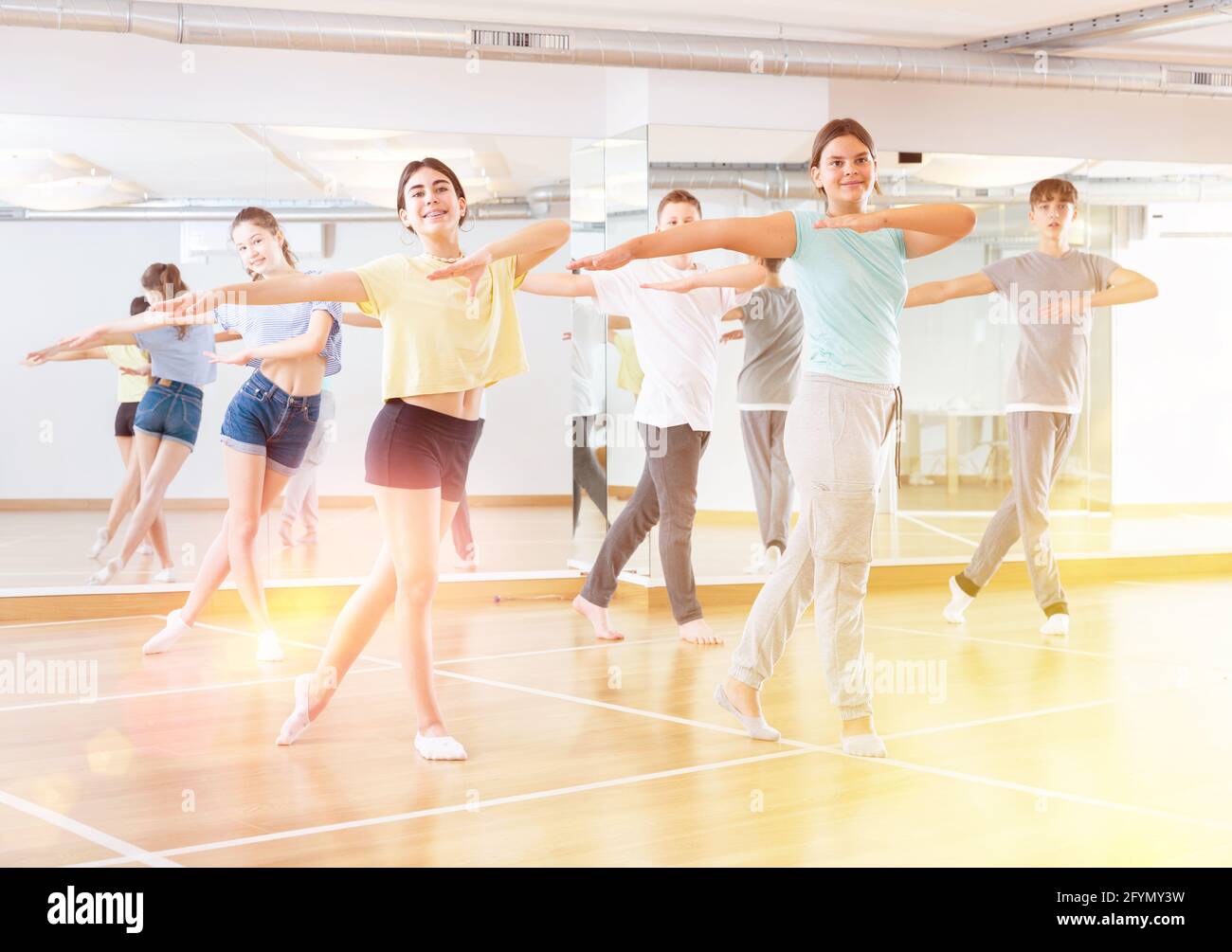 Positive teenagers are dancing hip hop in dance studio Stock Photo - Alamy