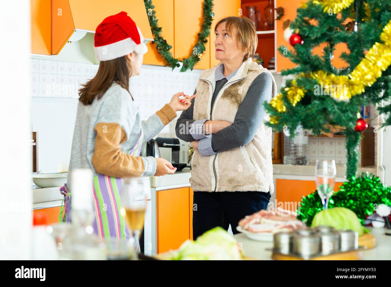 Angry senior woman having conflict with daughter during cooking xmas ...