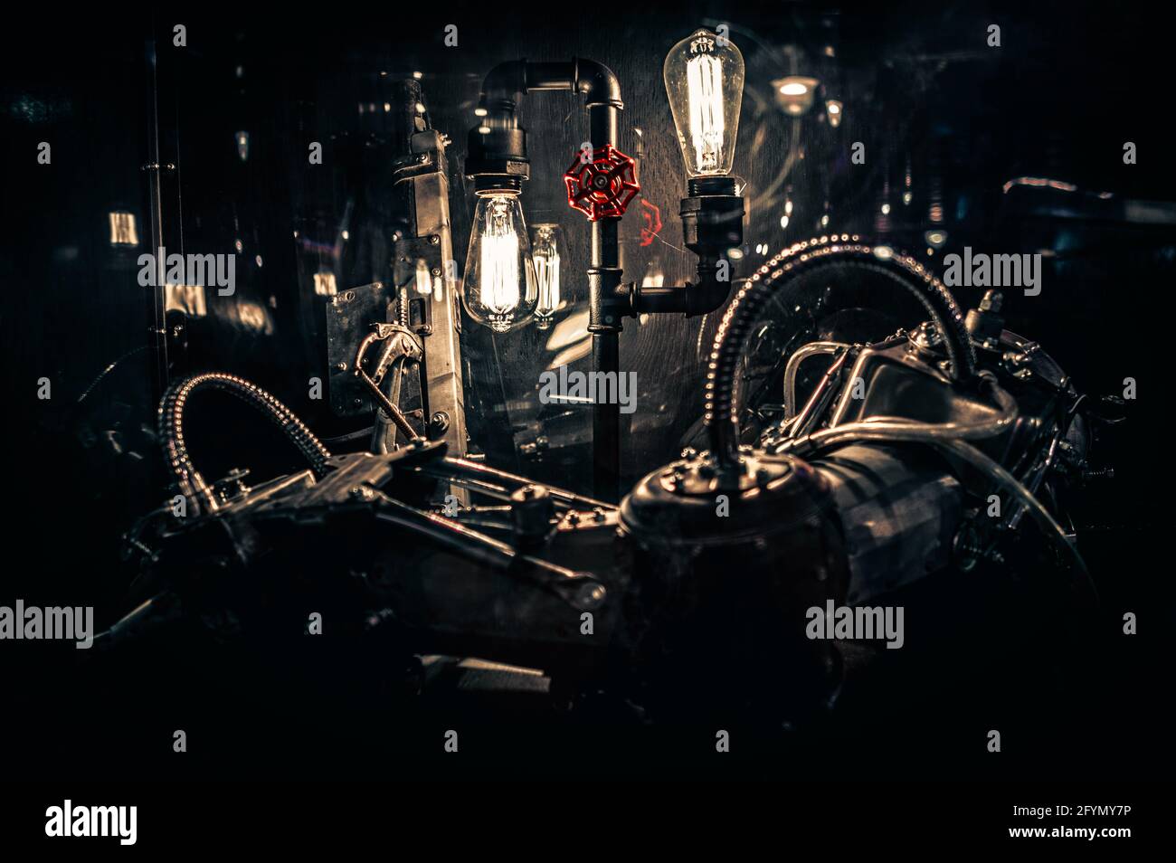 Broken mechanical arm and light bulbs in the dark Stock Photo - Alamy