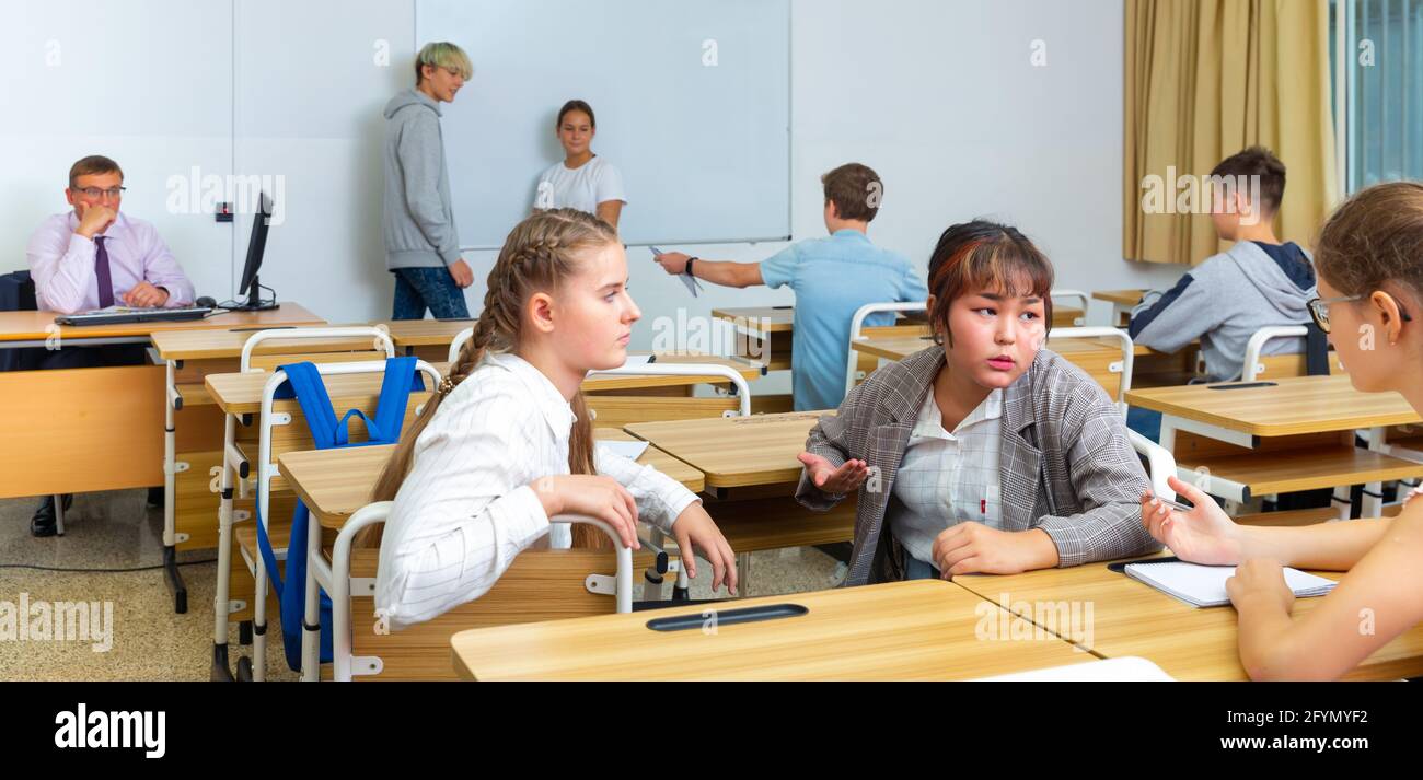 Teenage students talking and having fun, spending time together during ...