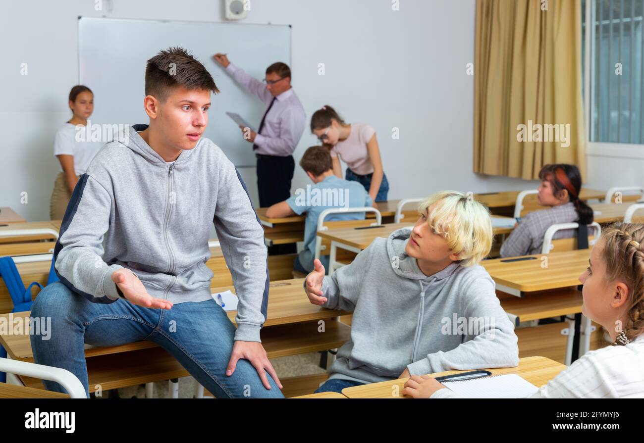 Teenage students talking and having fun, spending time together during ...