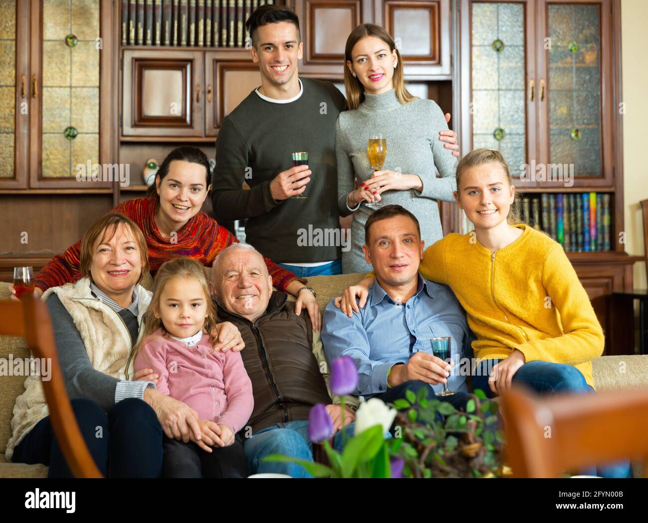 Portrait of big happy family gathering in parental home, posing ...