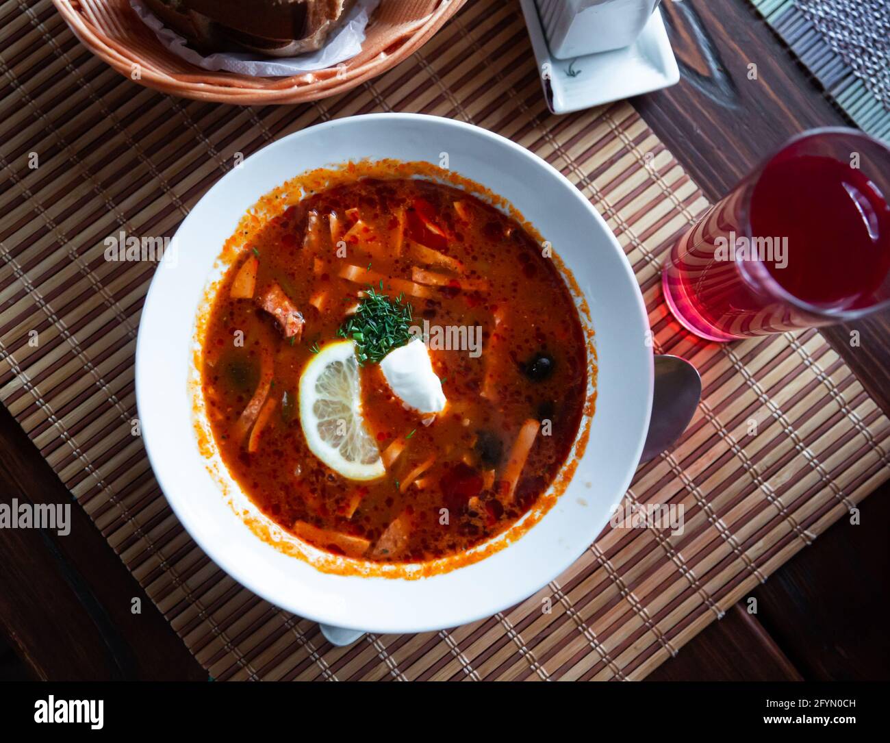 Traditional Russian meat soup solyanka with assorted meat and sausages ...