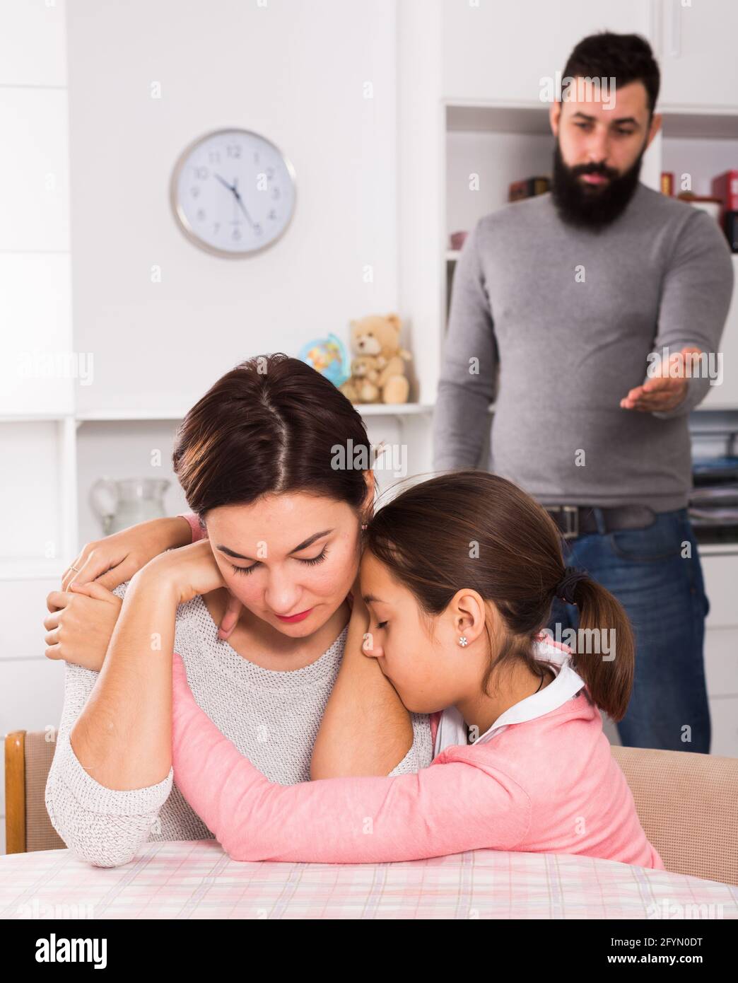 Young father correcting his wife and child for disobedience at home ...