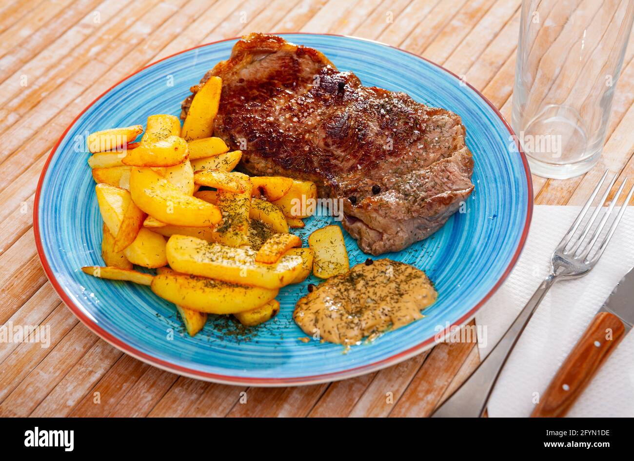 Beef entrecote with potatoes served at plate Stock Photo - Alamy