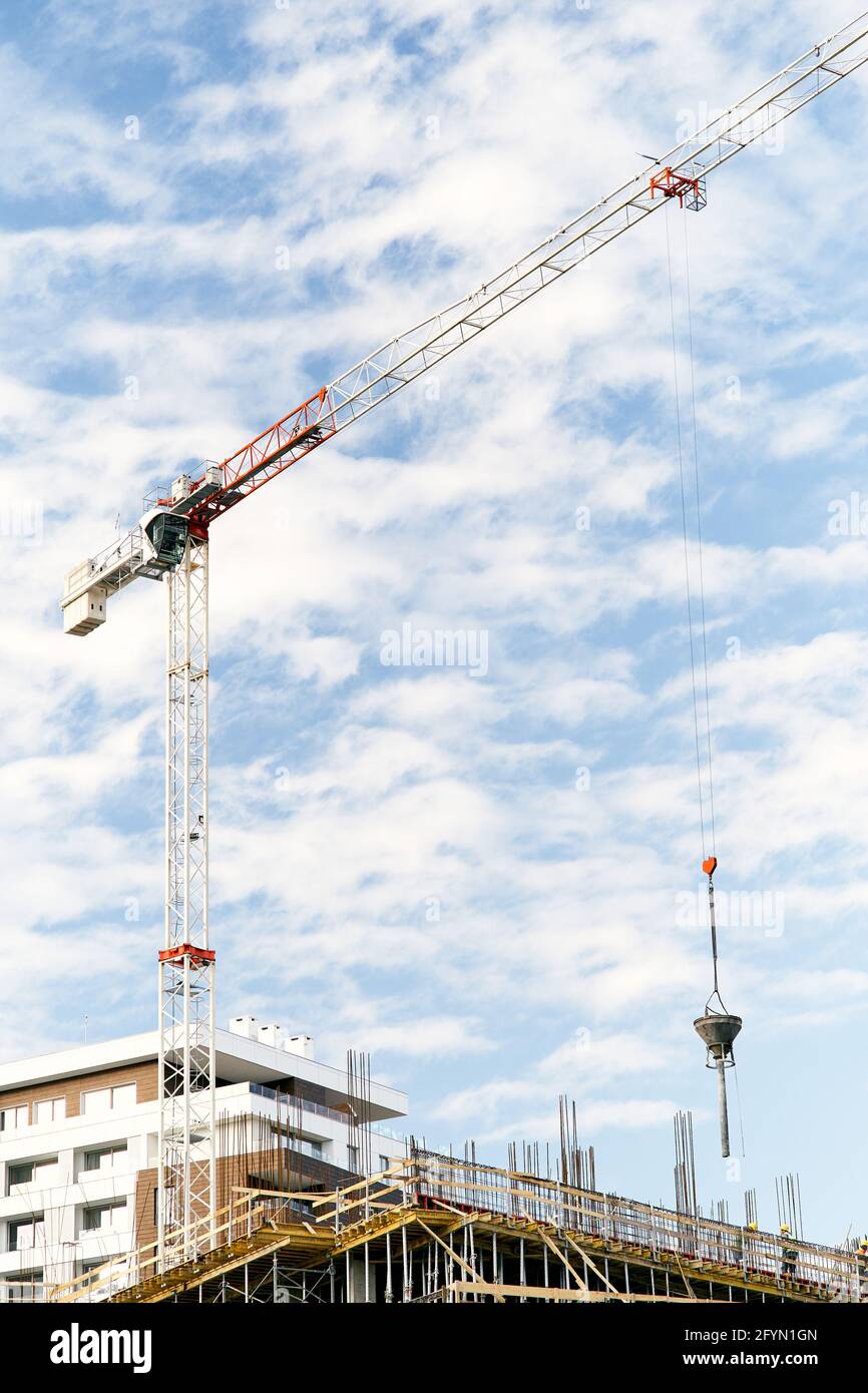 Tower crane works on the construction site of a multi-storey building ...