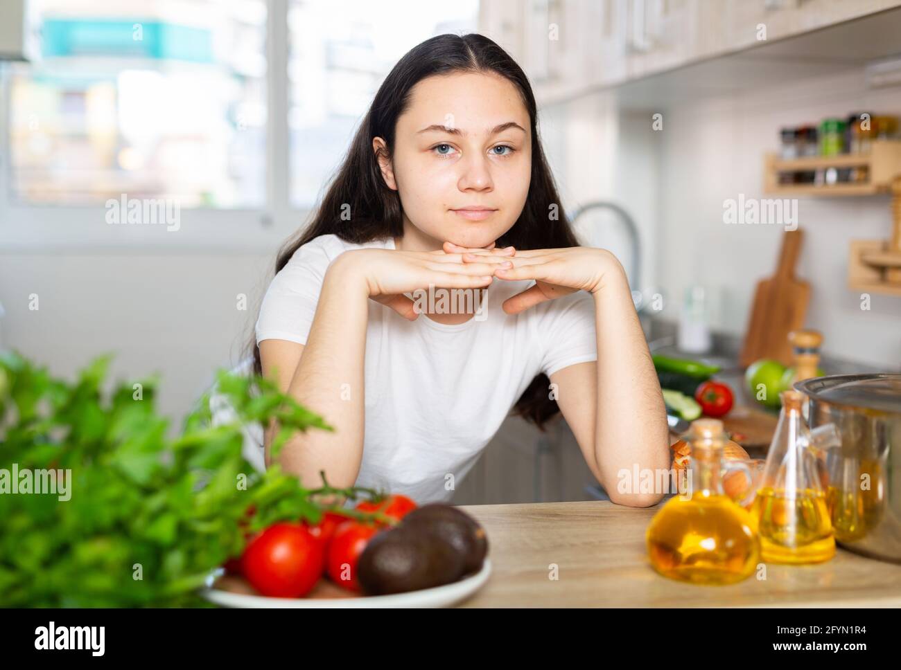Attractive young woman in casual clothing standing in kitchen Stock ...