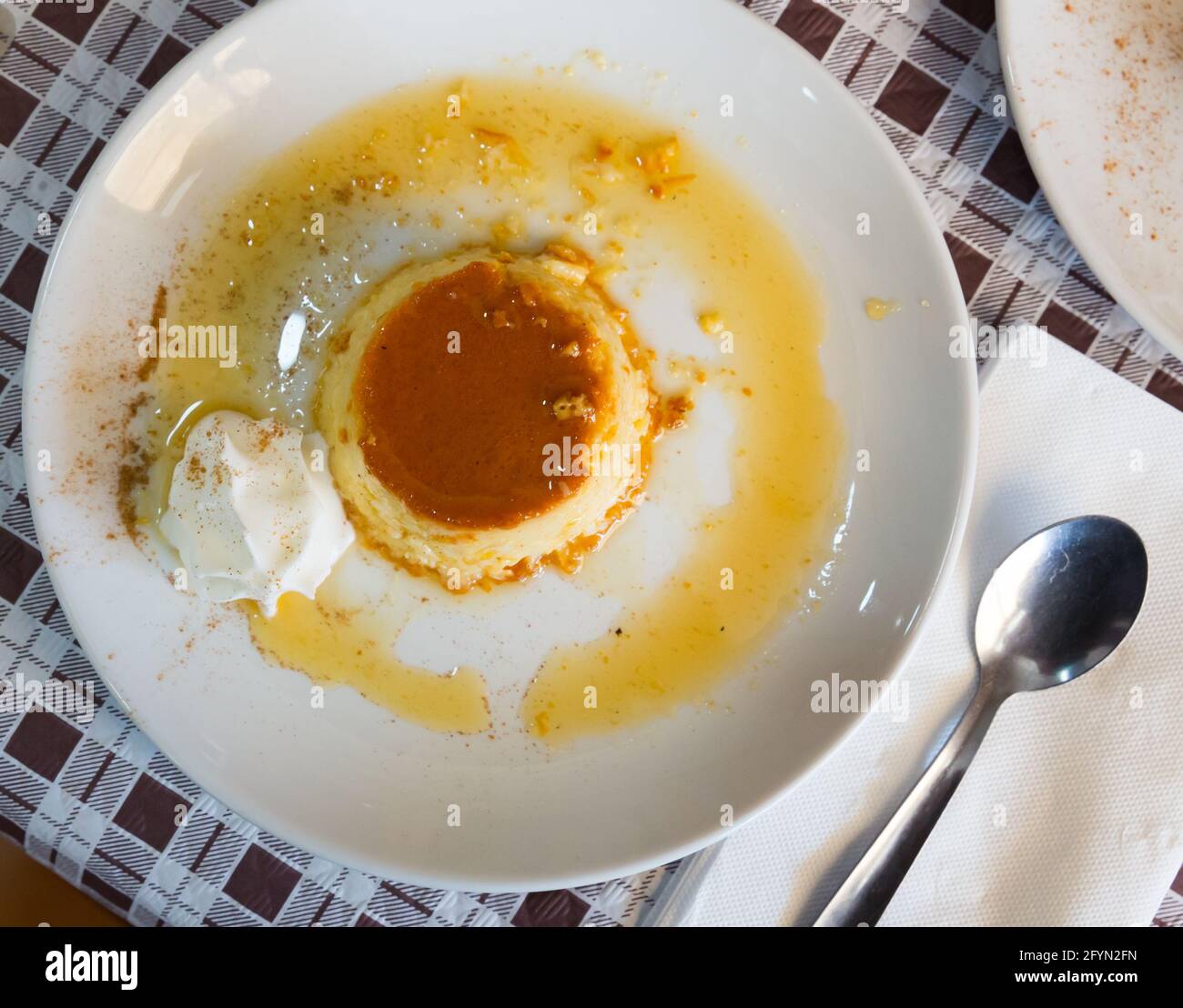Typical catalan creme dessert flan con nata with caramel crust at plate ...